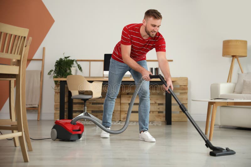 Young Man Using Vacuum Cleaner in Living Room Stock Image - Image of ...