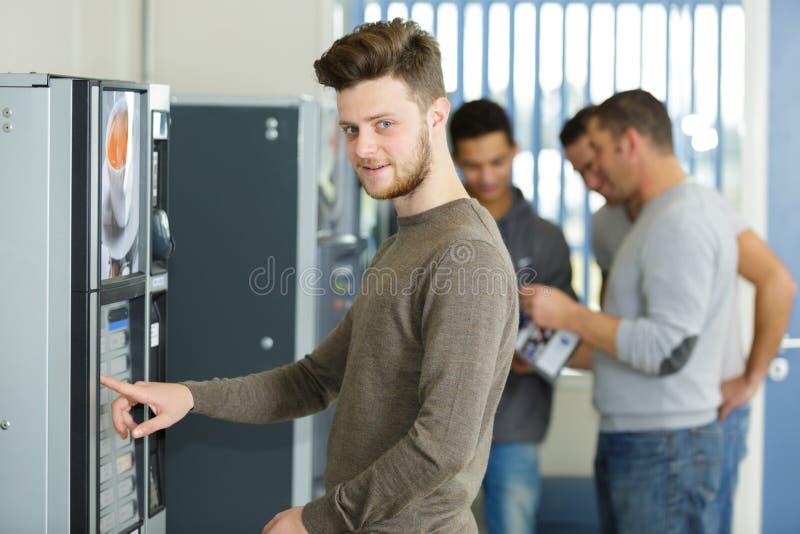 Young Man Using Vending Machine Stock Photo - Image of choose, machine ...