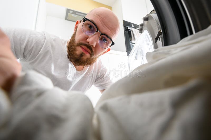 Young Man Using Washing Machine at Home. Laundry Day Stock Photo ...