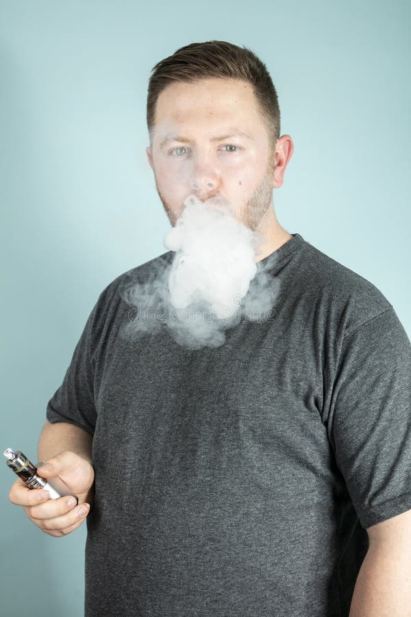 Young Man Vaping Smoking an E-cigarette Stock Image - Image of cloud ...