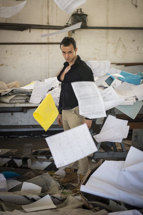 Young Man in Very Messy Office with Documents Flying Stock Photo ...