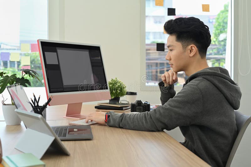 Young Man Video Editor Working with Footage and Post Production Montage ...