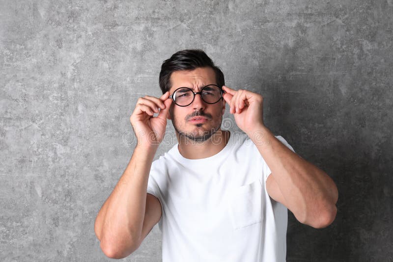 Young Man with Vision Problem Wearing Glasses on Background Stock Image ...
