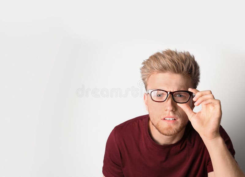Young Man with Vision Problems Holding Glasses Stock Photo - Image of ...