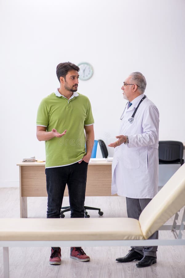 Young Man Visiting Old Male Doctor Stock Photo - Image of diagnostic ...