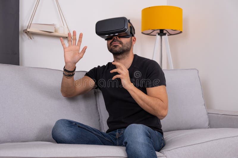Young Man in VR Glasses Headset at Home Interacting with Virtual ...