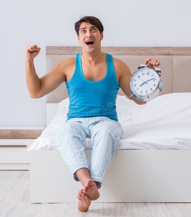 Young man waking up in bed stock image. Image of missing - 329362903