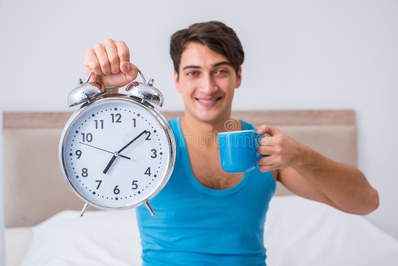 The Young Man Waking Up in Bed Stock Photo - Image of alarm, pyjamas ...
