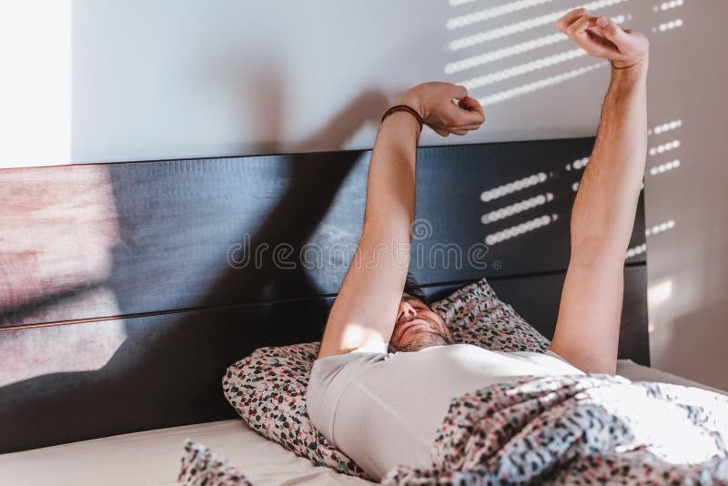 Young Man Waking Up in the Bed Stock Photo - Image of sleepy, relax ...