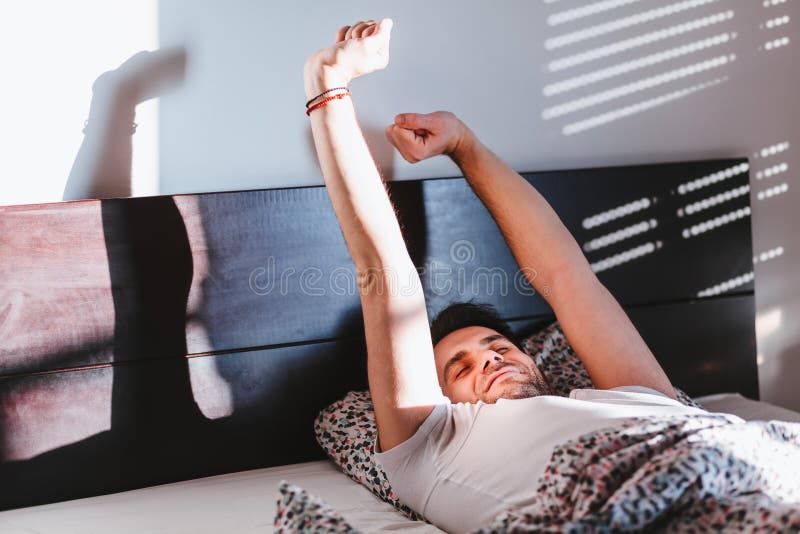 Young Man Waking Up in Bed in the Morning Stock Image - Image of casual ...