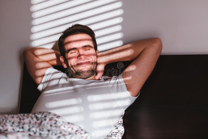 Young Man Waking Up in the Bed Stock Image - Image of male, relax ...