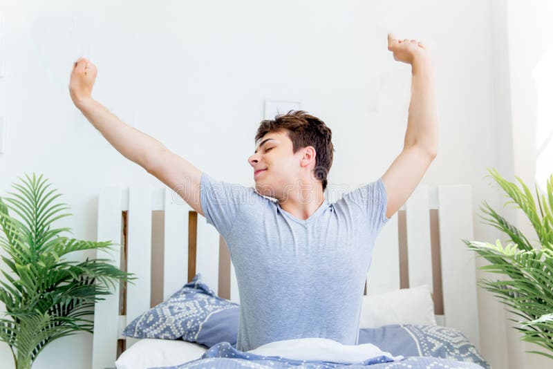 A Young Man Waking Up in Bed in the Morning Stock Image - Image of rest ...
