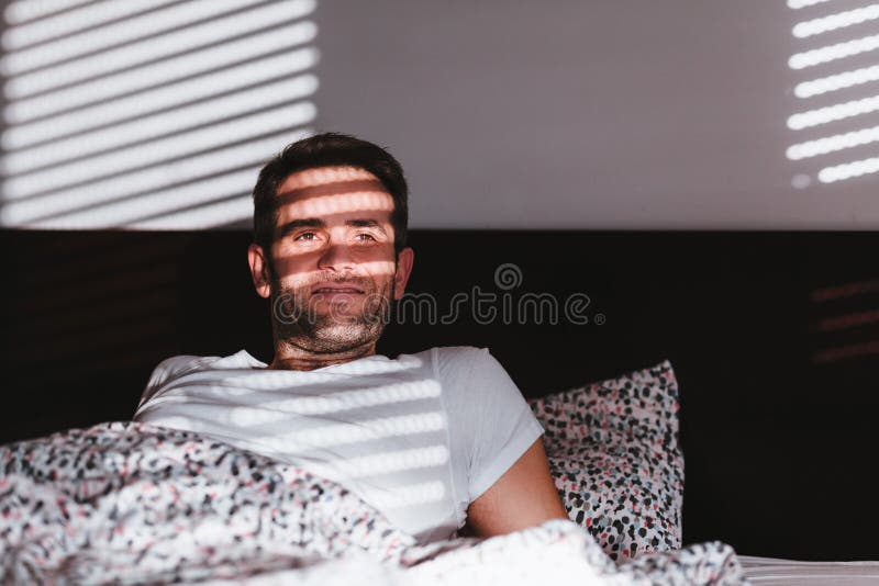 Young Man Waking Up in Bed in the Morning Stock Image - Image of casual ...