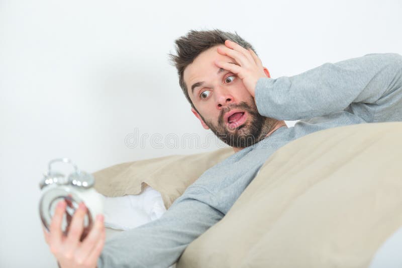 Young man waking up late stock photo. Image of resting - 296715280