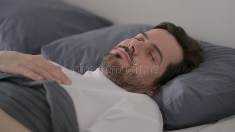 Young Man Waking Up from Sleep in Bed Stock Image - Image of ...