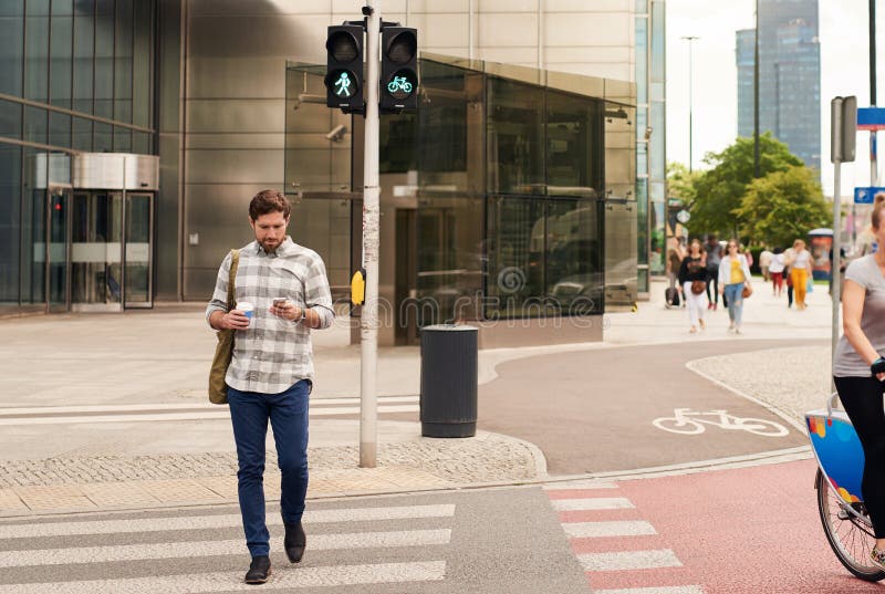 Young Man Walking through the City Using a Cellphone Stock Image ...