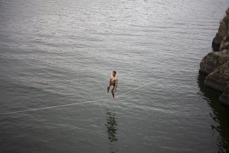 Young Man Walking on a Rope Over Water. Stock Image - Image of sports ...