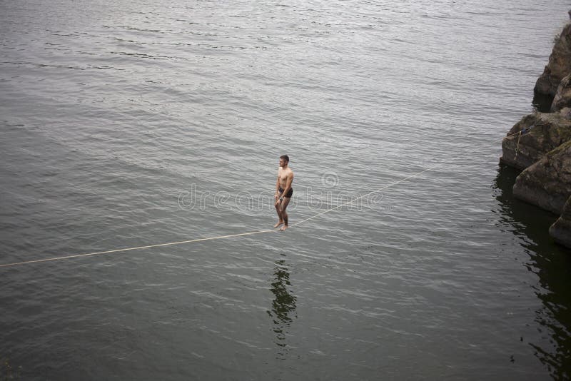 Young Man Walking on a Rope Over Water. Stock Image - Image of stretch ...