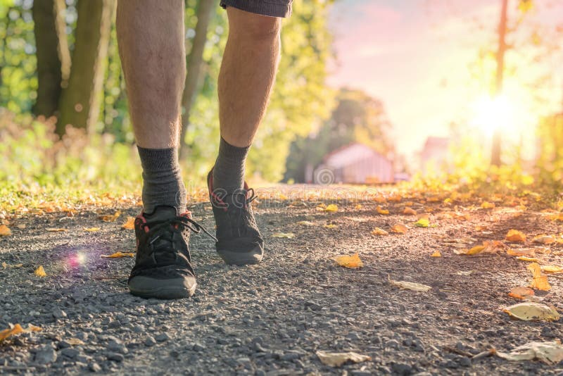 Young Man is Walking or Running at Sunset. View on Legs and Feet Stock ...