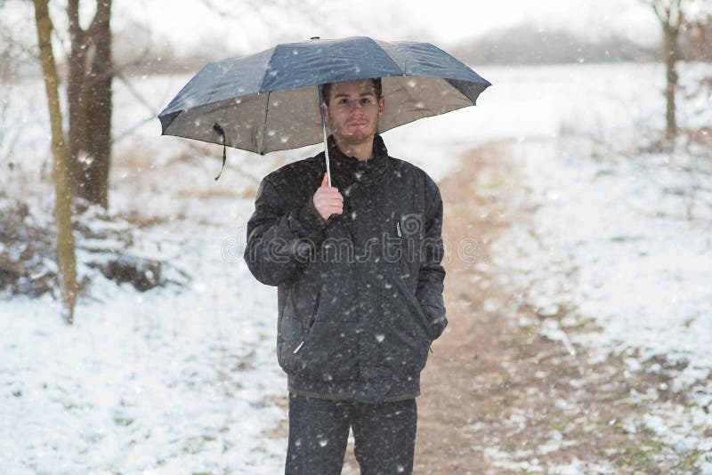 Young Man Walking in the Snowfall Stock Image - Image of snowstorm ...