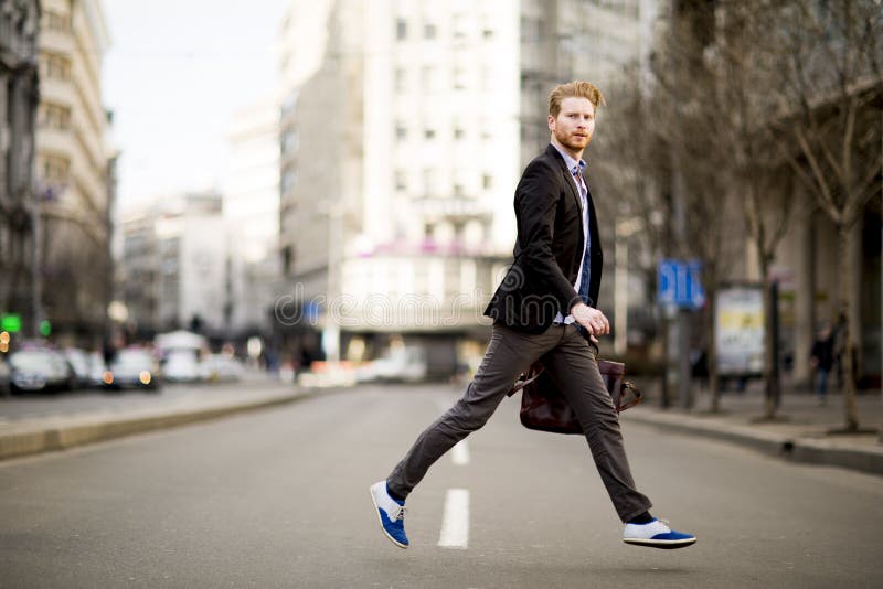 Young Man Walking on the Street Stock Photo - Image of walking ...