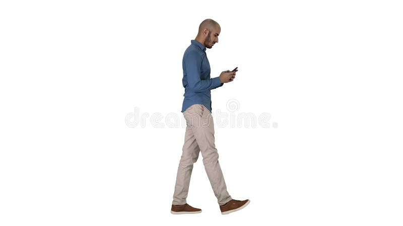 Young Man Walking and Using a Phone on White Background. Stock Photo ...
