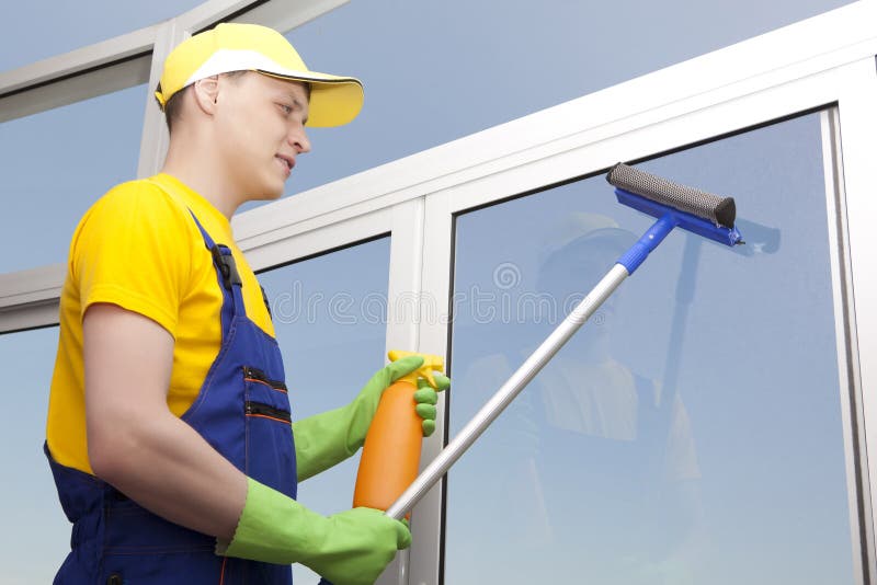 Young man washes window stock photo. Image of spray, pressurised - 91429332