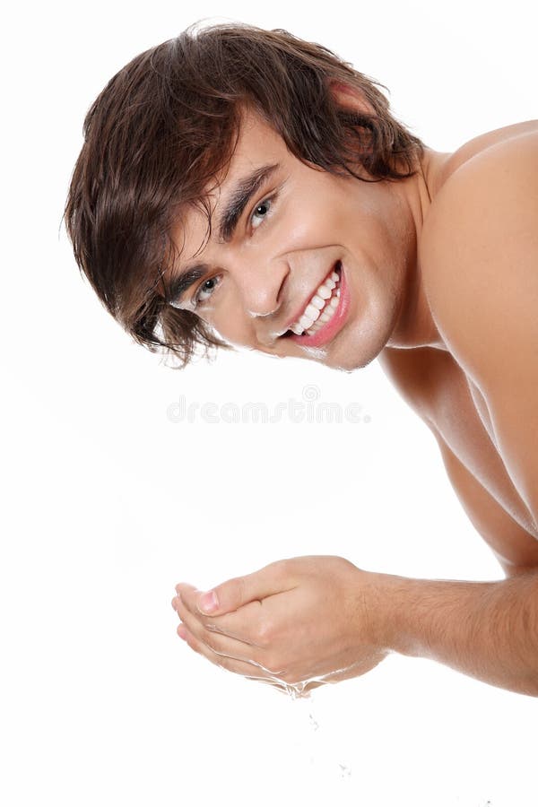Young man washing his face stock image. Image of care - 18753481