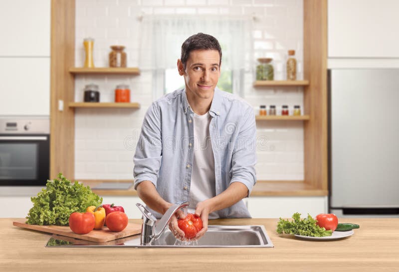 Young Man Washing Tomato in a Kitchen Sink Stock Photo - Image of home, smile: 339166724