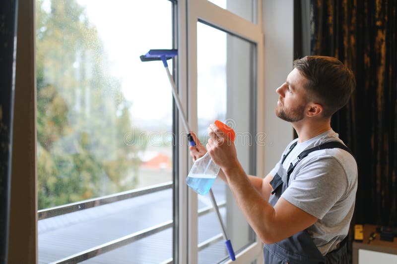 Young Man Washing Window in Office Stock Photo - Image of caucasian ...