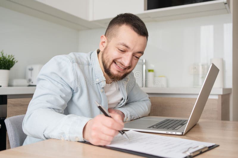 Young Man Watching Educational Webinar Lecture on Computer, Writing ...