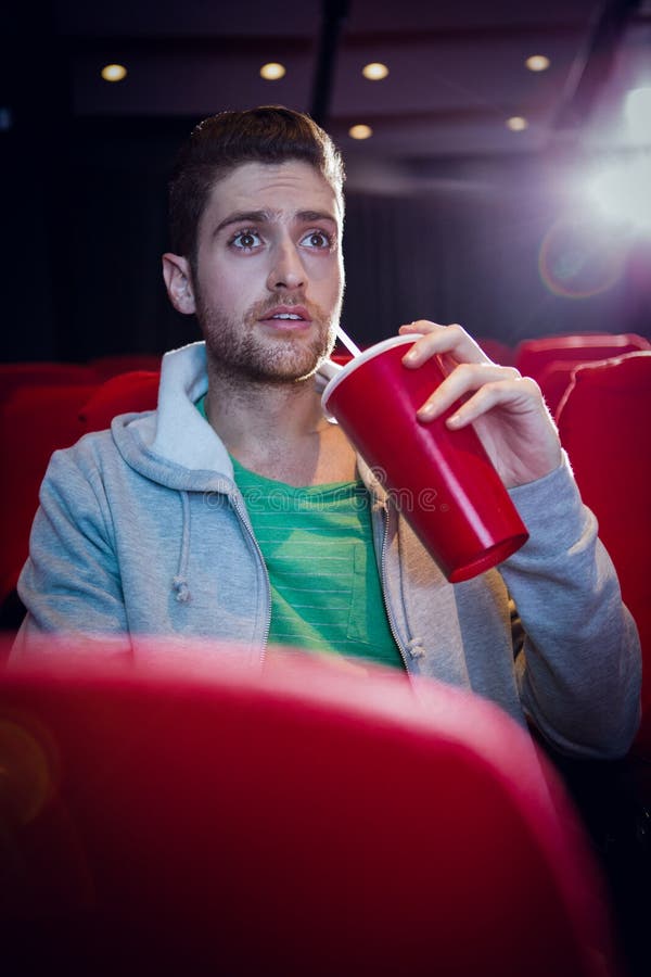 Young man watching a film stock photo. Image of theater - 53082266