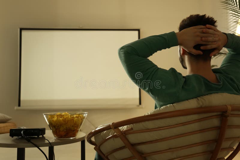 Young Man Watching Movie Using Video Projector Stock Image - Image of ...