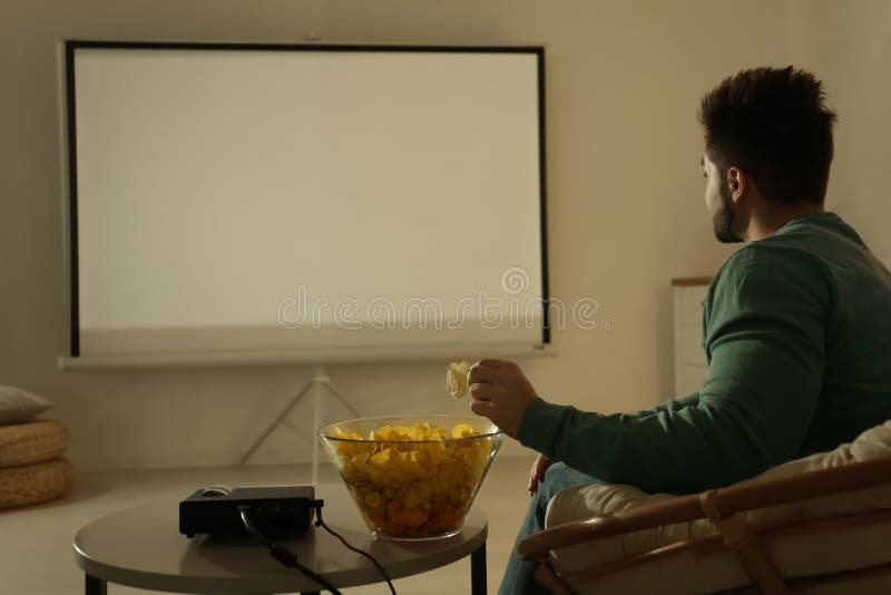Young Man Watching Movie Using Video Projector Stock Image - Image of ...