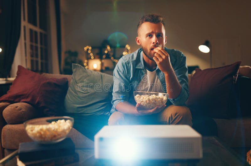 Young Man Watching Projector Tv at Home in Evening Alone Stock Photo ...