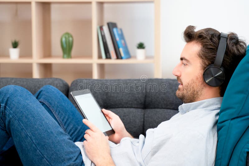Young Man Watching Streaming Movie and Using Digital Tablet Stock Image ...