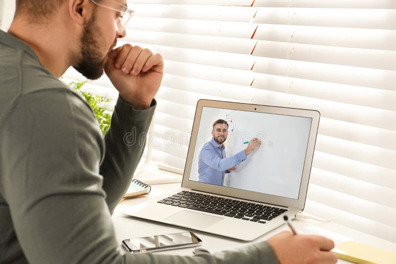 Young Man Watching Video at Desk. Online Learning Stock Image - Image ...