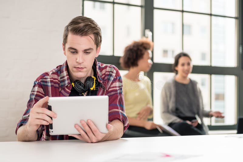 Young Man Watching a Video on Tablet PC at Work Stock Image - Image of ...