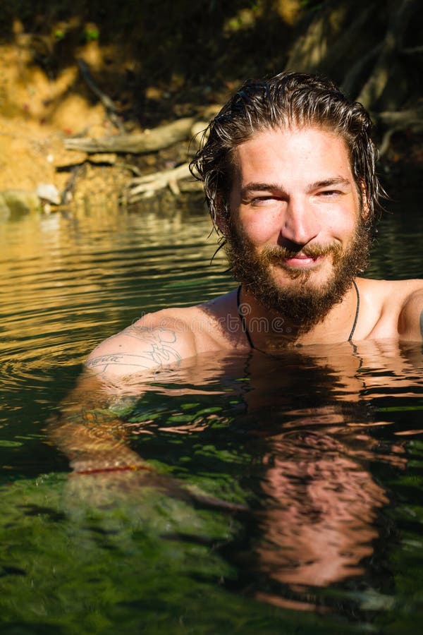 Young man in water stock image. Image of camera, water - 27730961