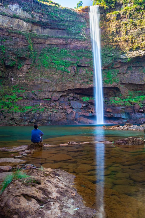 Young Man at Waterfall Falling Streams from Mountain Top with ...