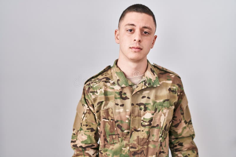 Young Man Wearing Camouflage Army Uniform Relaxed with Serious ...