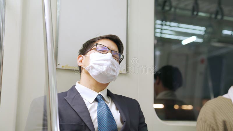 Young Man Wearing Face Mask Travels On Crowded Subway Train Stock Image