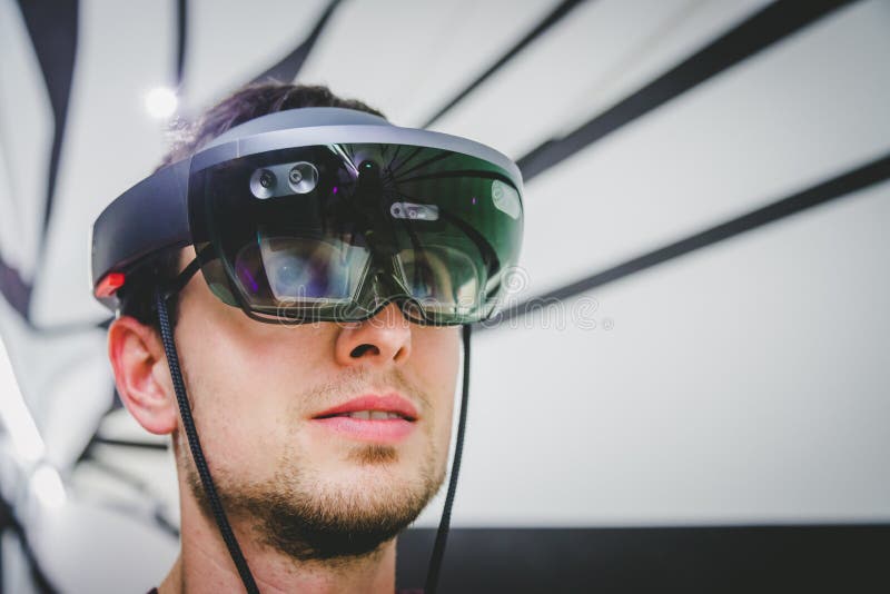 Young Man Wearing High End Virtual Reality Glasses. Concept for VR ...