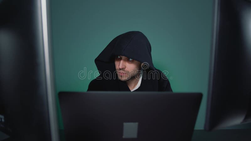 Man Hacker in Black Hood Working with Several Computers Stock Footage ...
