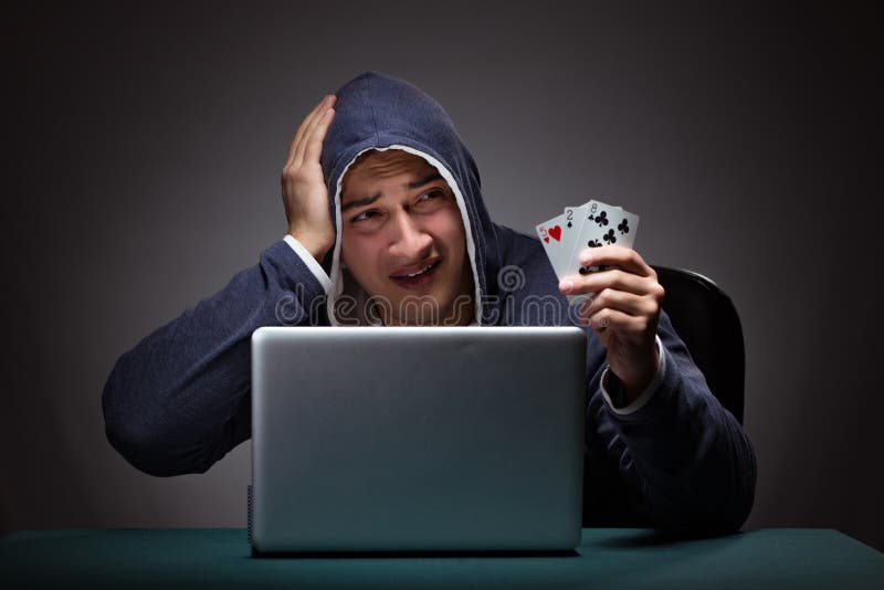Young Man Wearing a Hoodie Sitting in Front of a Laptop Computer Stock ...