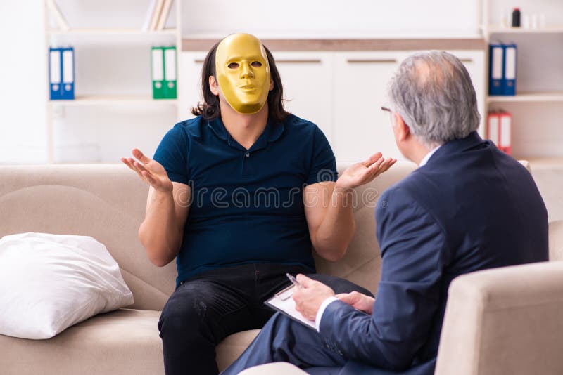 Young Man Wearing Masks during Psychotherapy Session Stock Photo ...