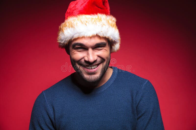 Young Man Wearing a Red Santa Hat Smiling Stock Photo - Image of ...