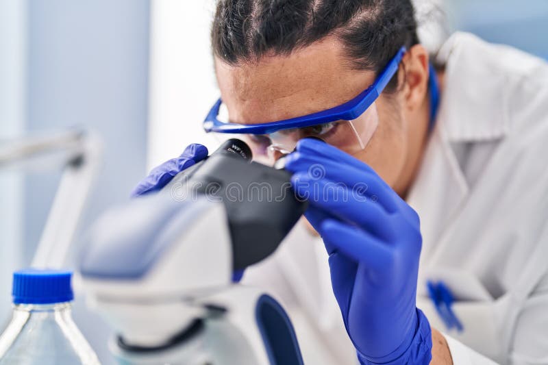 Young Man Wearing Scientist Uniform Using Microscope at Laboratory ...