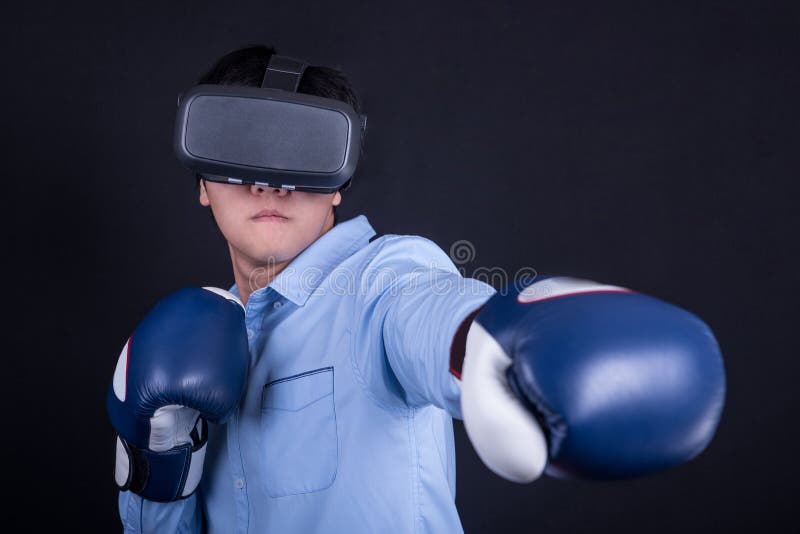 Young Man Wearing Virtual Reality Goggles and Boxing Gloves Stock Photo ...