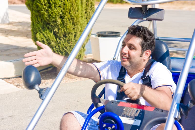 Young Man at Wheel of Buggy Shows Hand Aside Stock Image - Image of ...